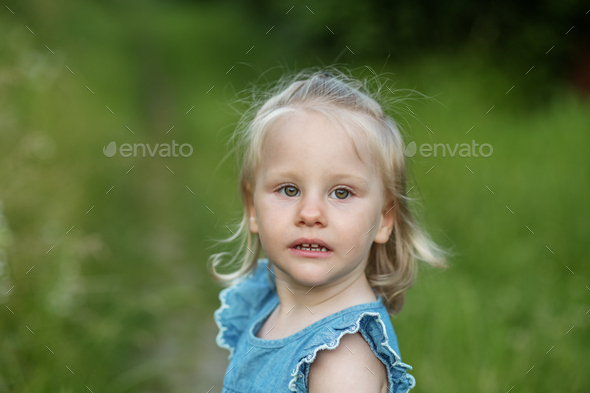 Portrait of preschool girl. Beautiful blond child with brown eyes. Summer day in park. Stock ...